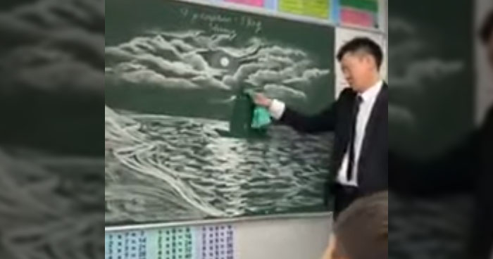 Primary School Teacher Drawing For The Class Using Chalk On Board ...
