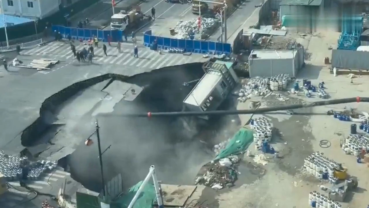 Ground collapses in Shanghai, massive sinkhole swallows busy road ...